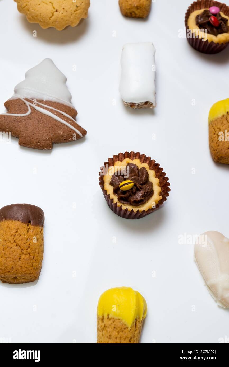 Vertical shot of different kind of cookies isolated on a white ...