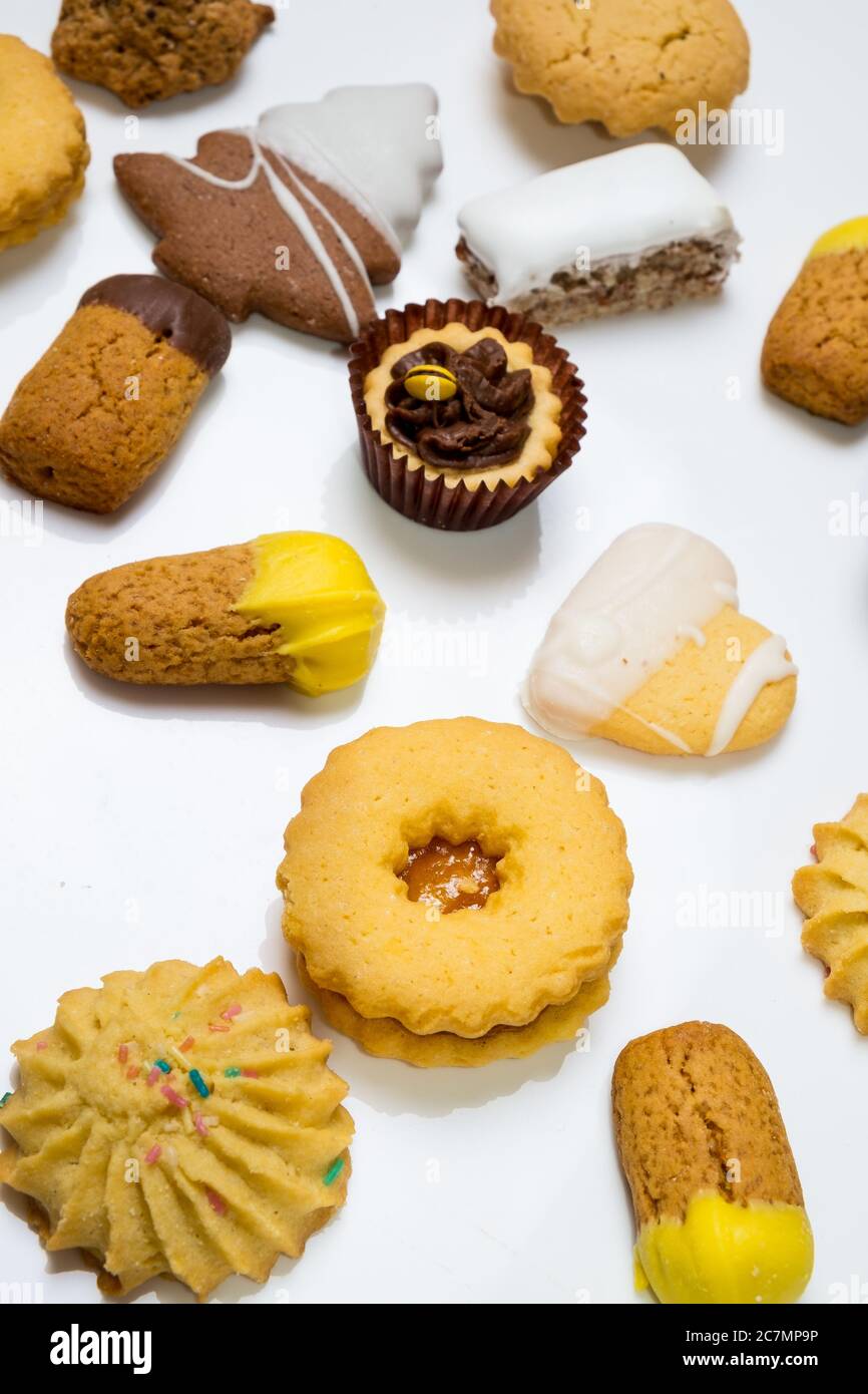 Vertical shot of different kind of cookies isolated on a white ...