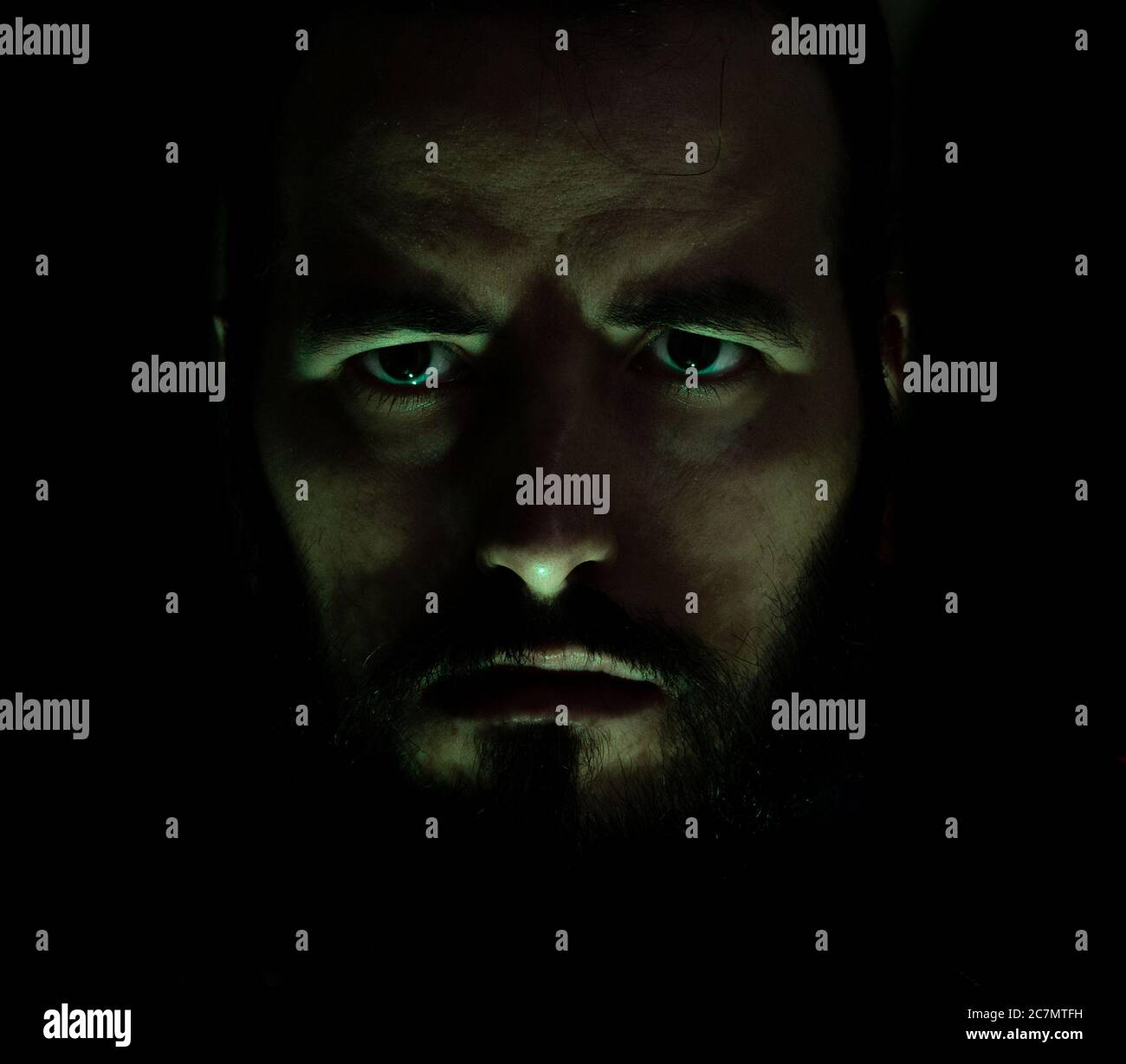 Closeup of a bearded male face looking angry Stock Photo - Alamy