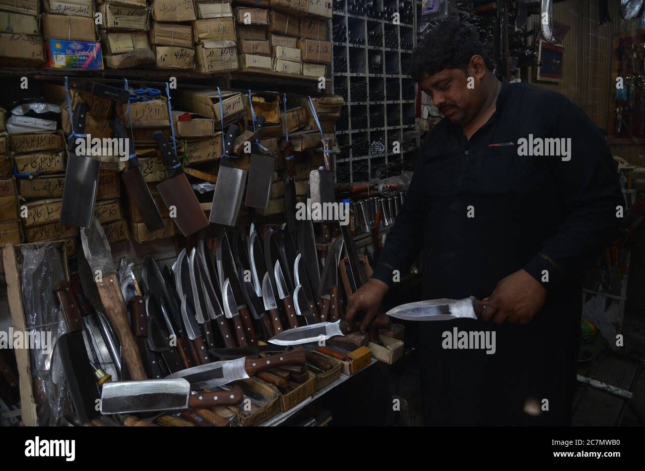 Pakistani blacksmiths sharpens meat cleavers various tools and knives ...
