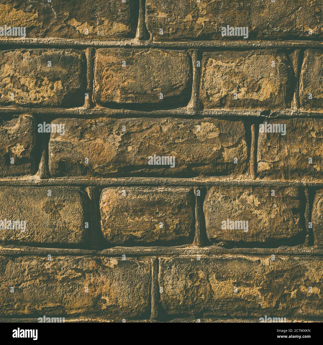 Wall made out of brown rectangular stones Stock Photo - Alamy