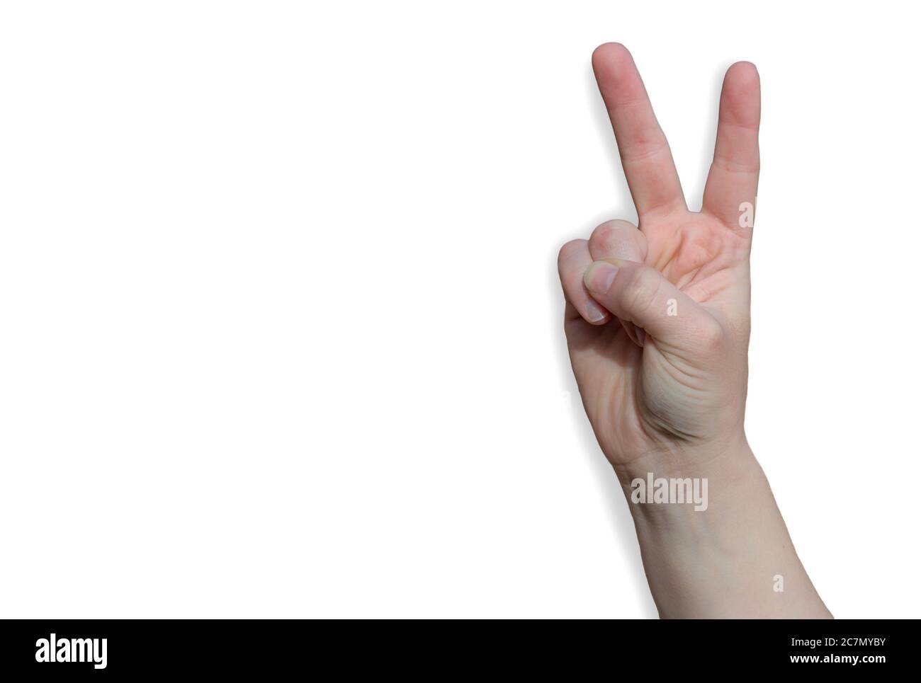 Raised arm making victory or peace gesture with fingers on a white ...