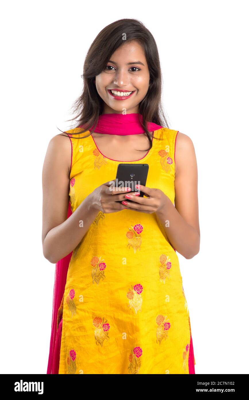 Young Indian girl using a mobile phone or smartphone isolated on a ...