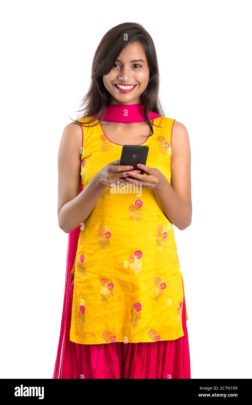 Young Indian girl using a mobile phone or smartphone isolated on a ...