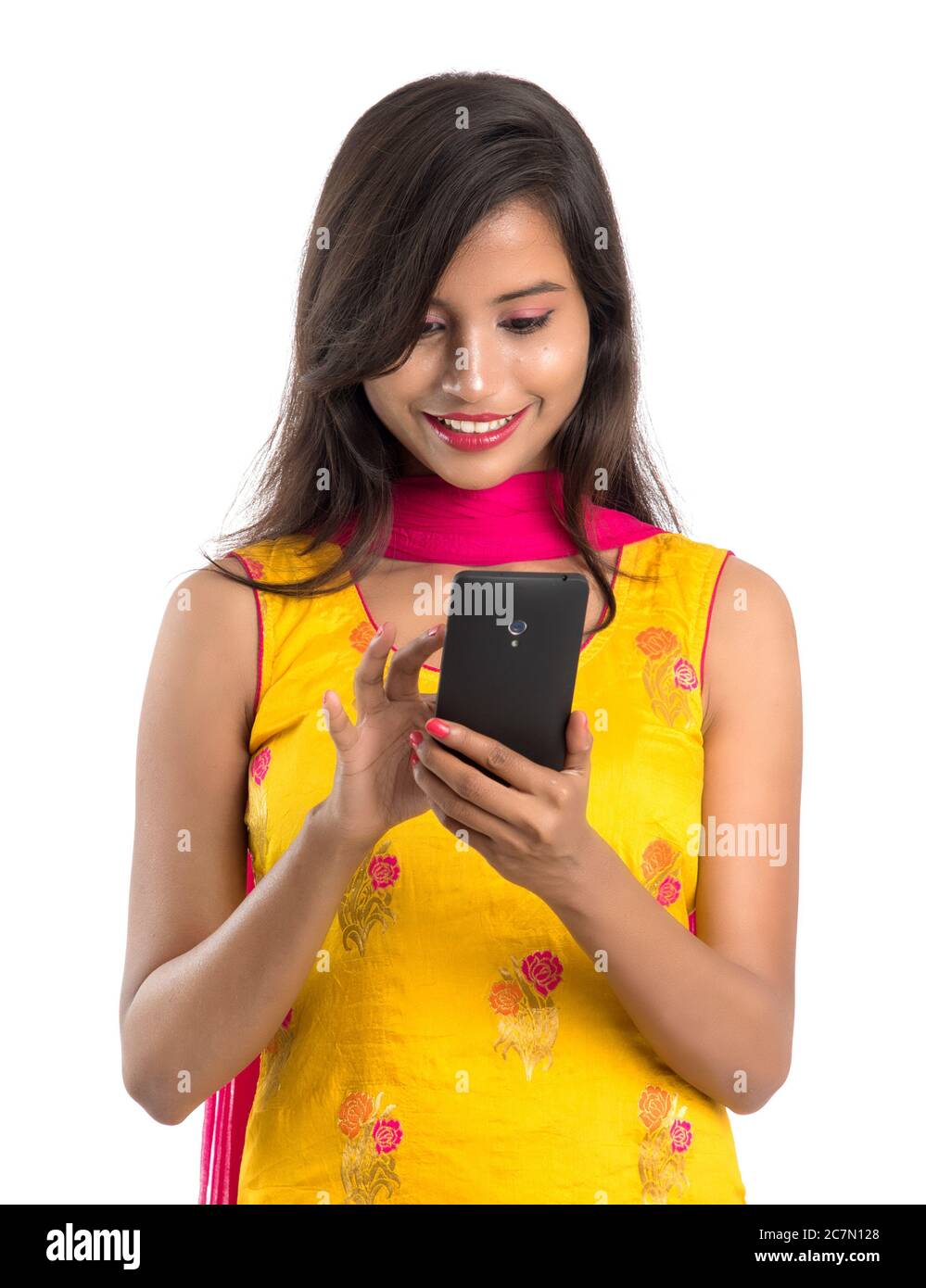 Young Indian girl using a mobile phone or smartphone isolated on a ...