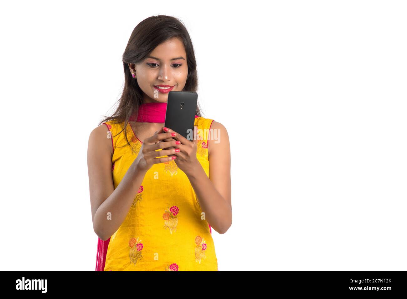 Young Indian girl using a mobile phone or smartphone isolated on a ...