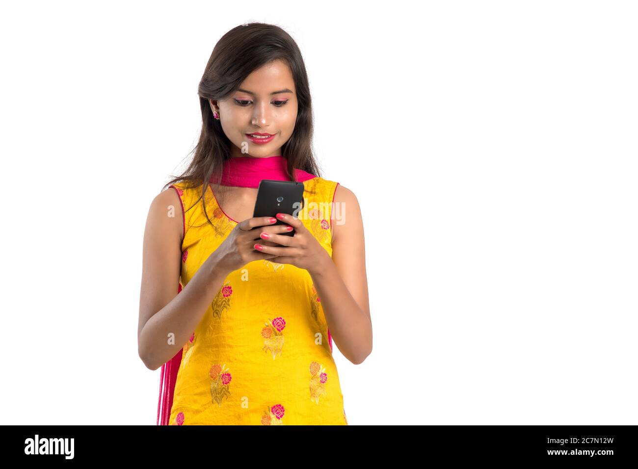 Young Indian girl using a mobile phone or smartphone isolated on a ...