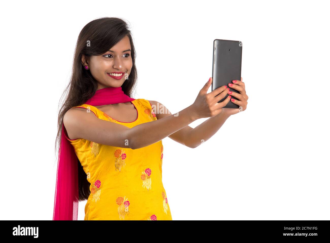 Young Indian girl using a mobile phone or smartphone isolated on a ...