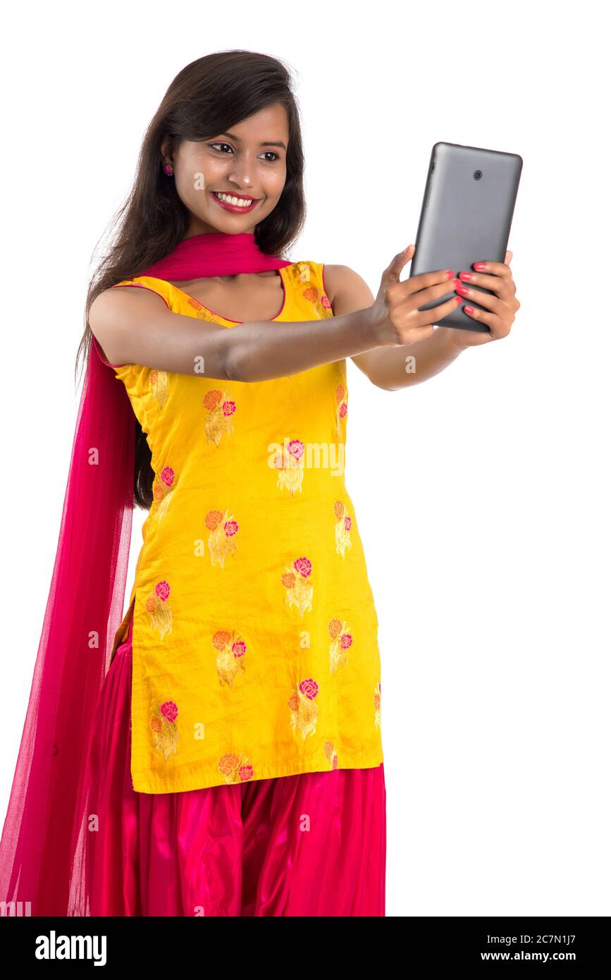 Young Indian girl using a mobile phone or smartphone isolated on a ...