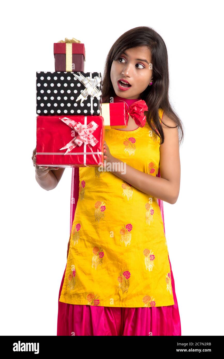 Portrait of young happy smiling Indian Girl holding gift boxes on a ...