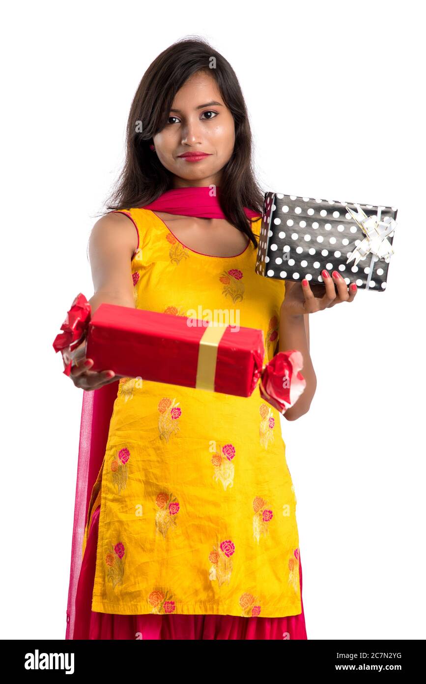 Portrait of young happy smiling Indian Girl holding gift boxes on a ...