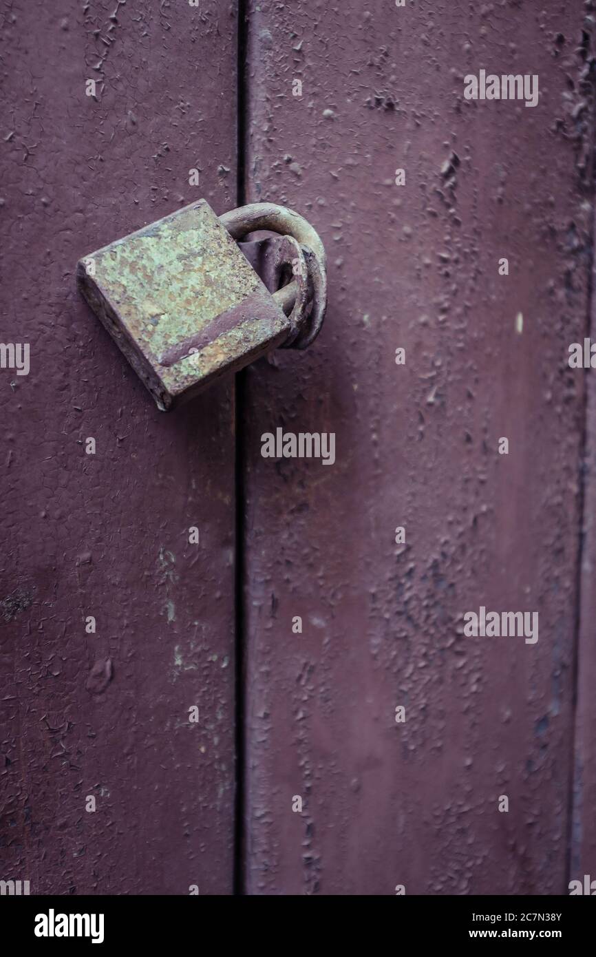 Lock attached to the doors of dark violet color Stock Photo - Alamy