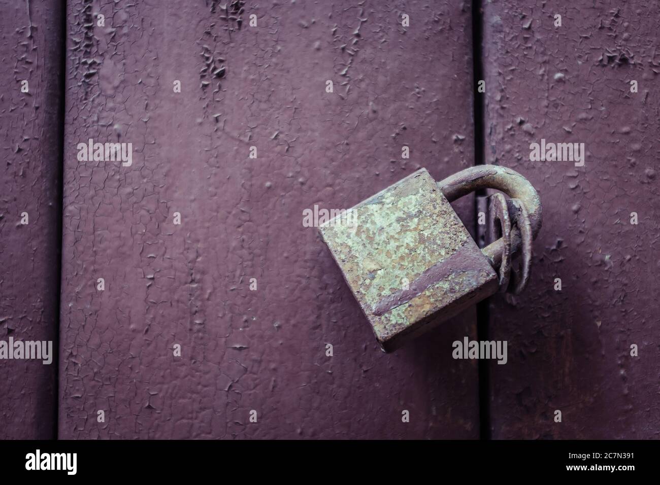 Lock attached to the doors of dark violet color Stock Photo - Alamy