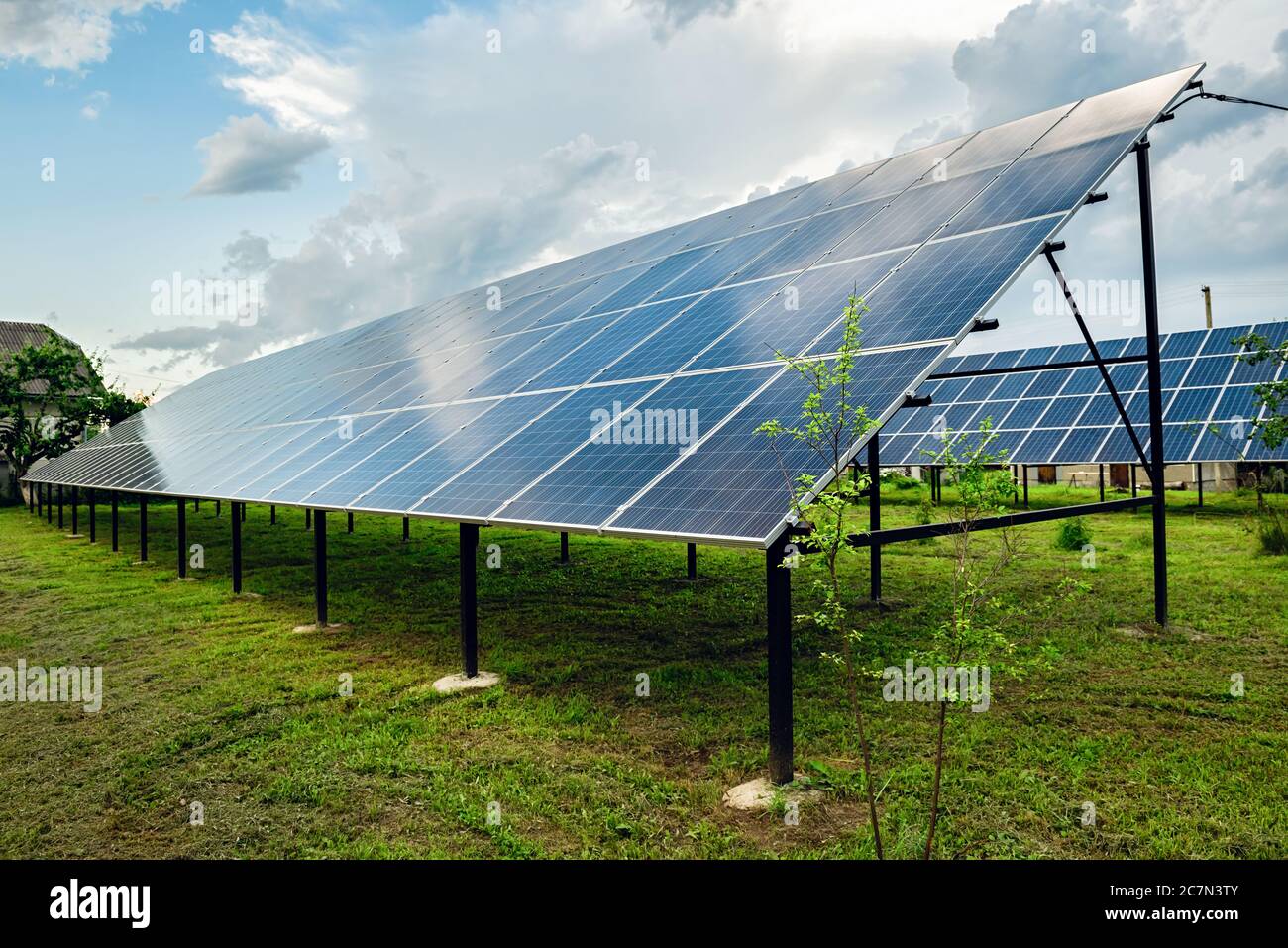 Solar panels in the garden. Solar power plant among trees and bushes ...