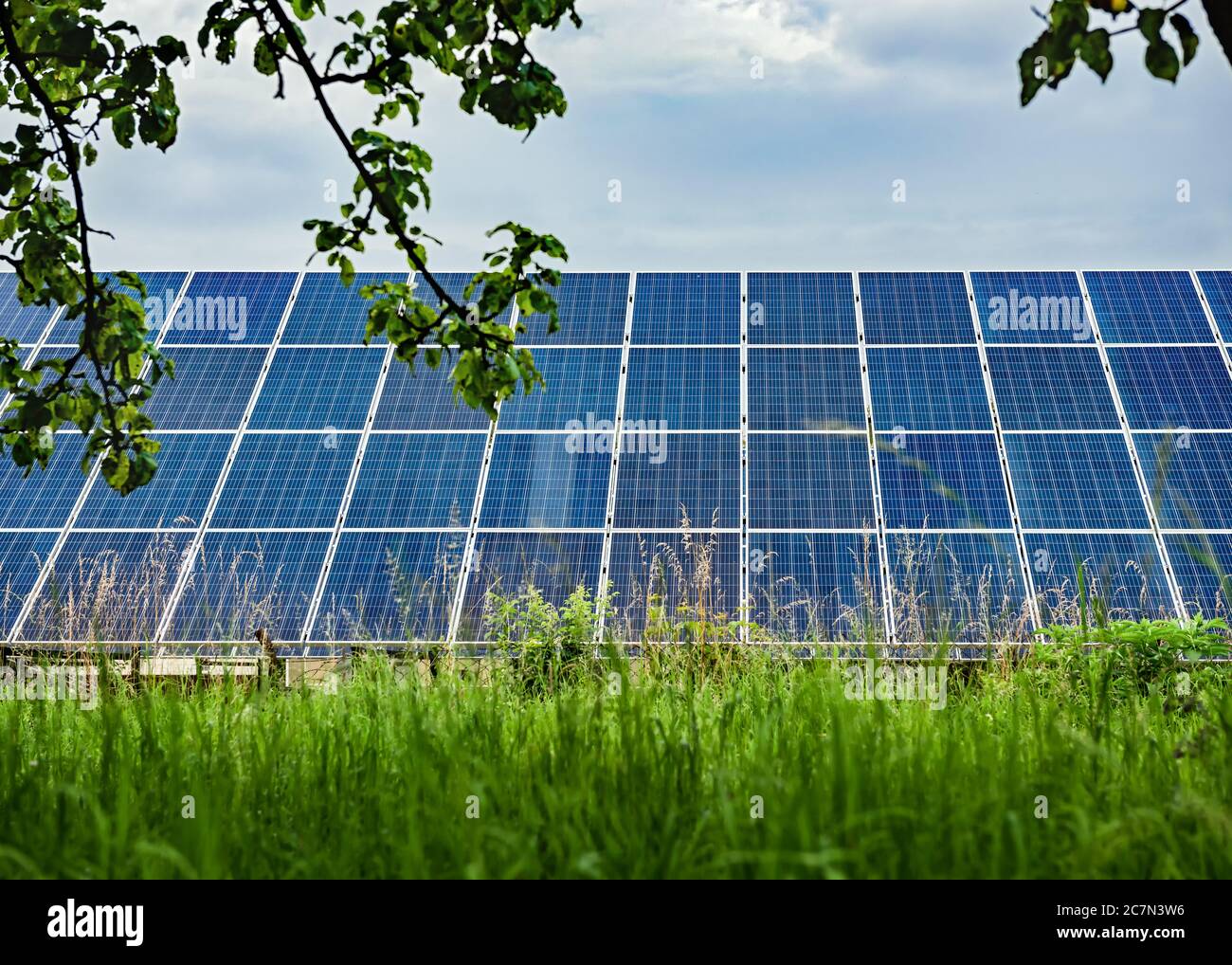 Solar panels in the garden. Solar power plant among trees and bushes ...