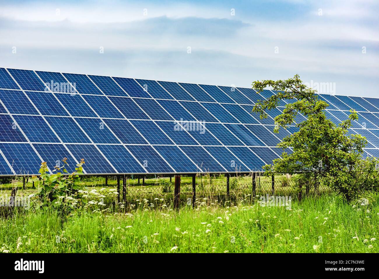 Solar panels in the garden. Solar power plant among trees and bushes ...