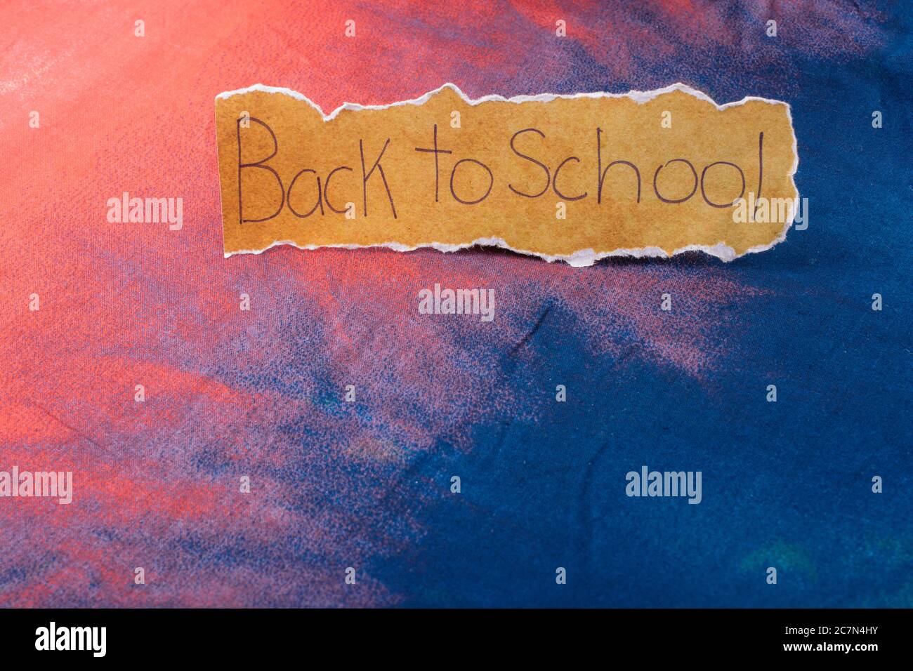 Back to school wording on a piece of torn paper Stock Photo - Alamy