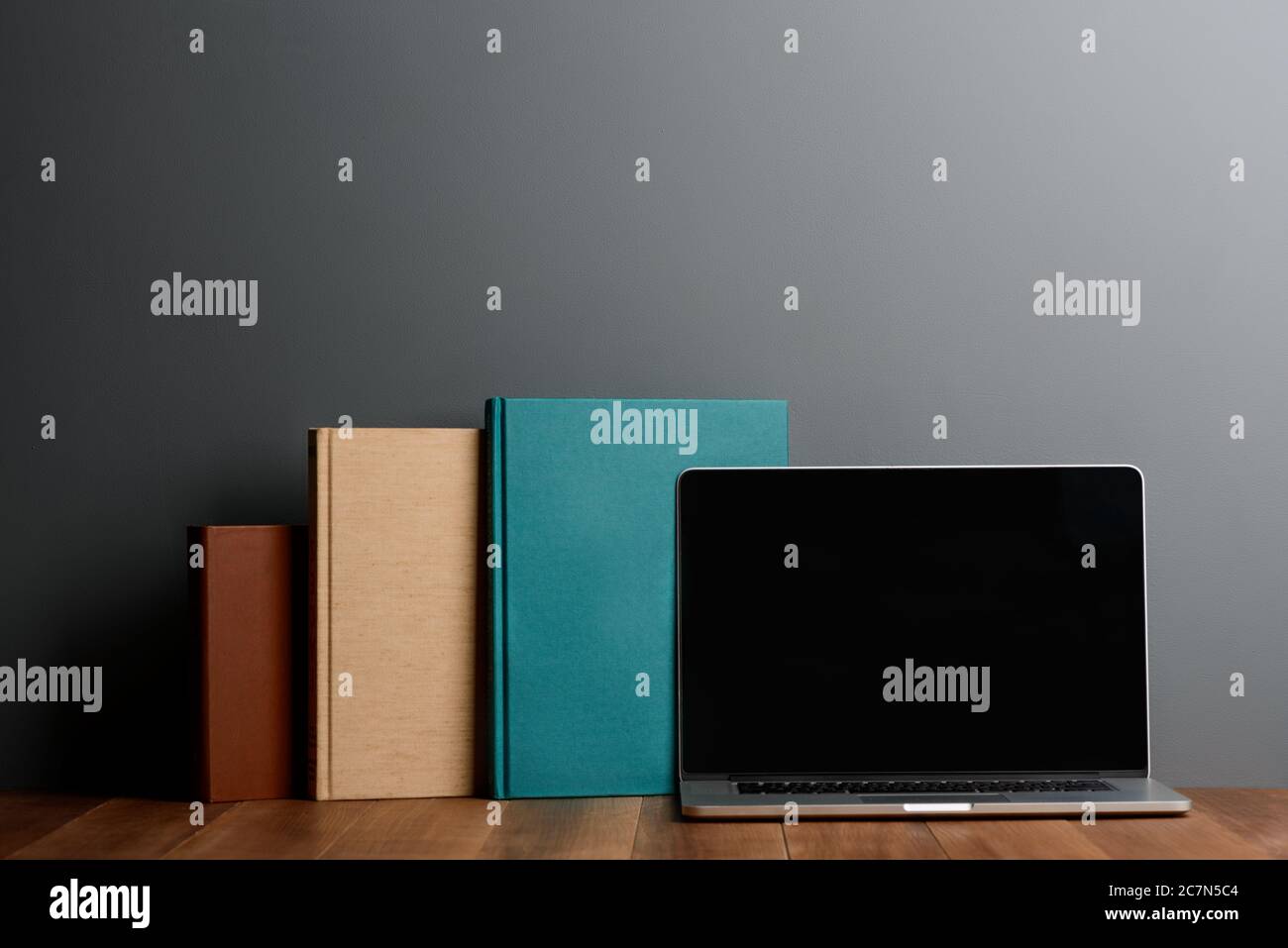 Books and notebook on desktop. Laptop mockup Stock Photo - Alamy