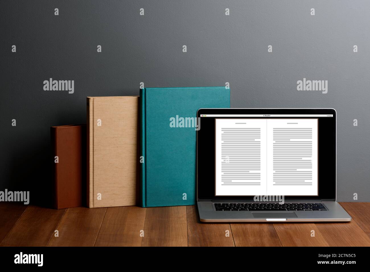 Books and laptop with E-reader app on desktop Stock Photo - Alamy