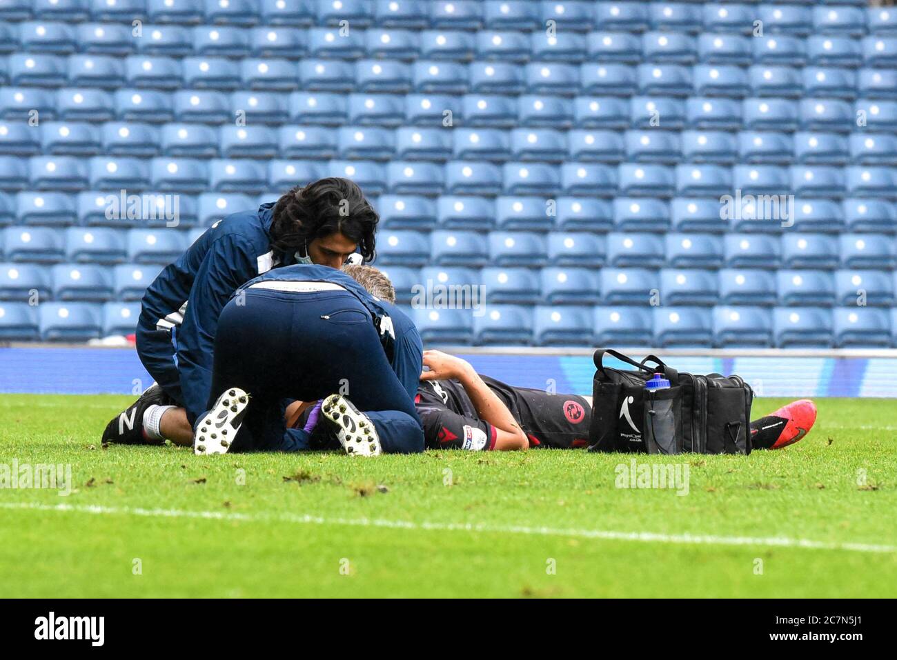 Tom McIntyre (16) of Reading receives treatment on the pitch Stock ...