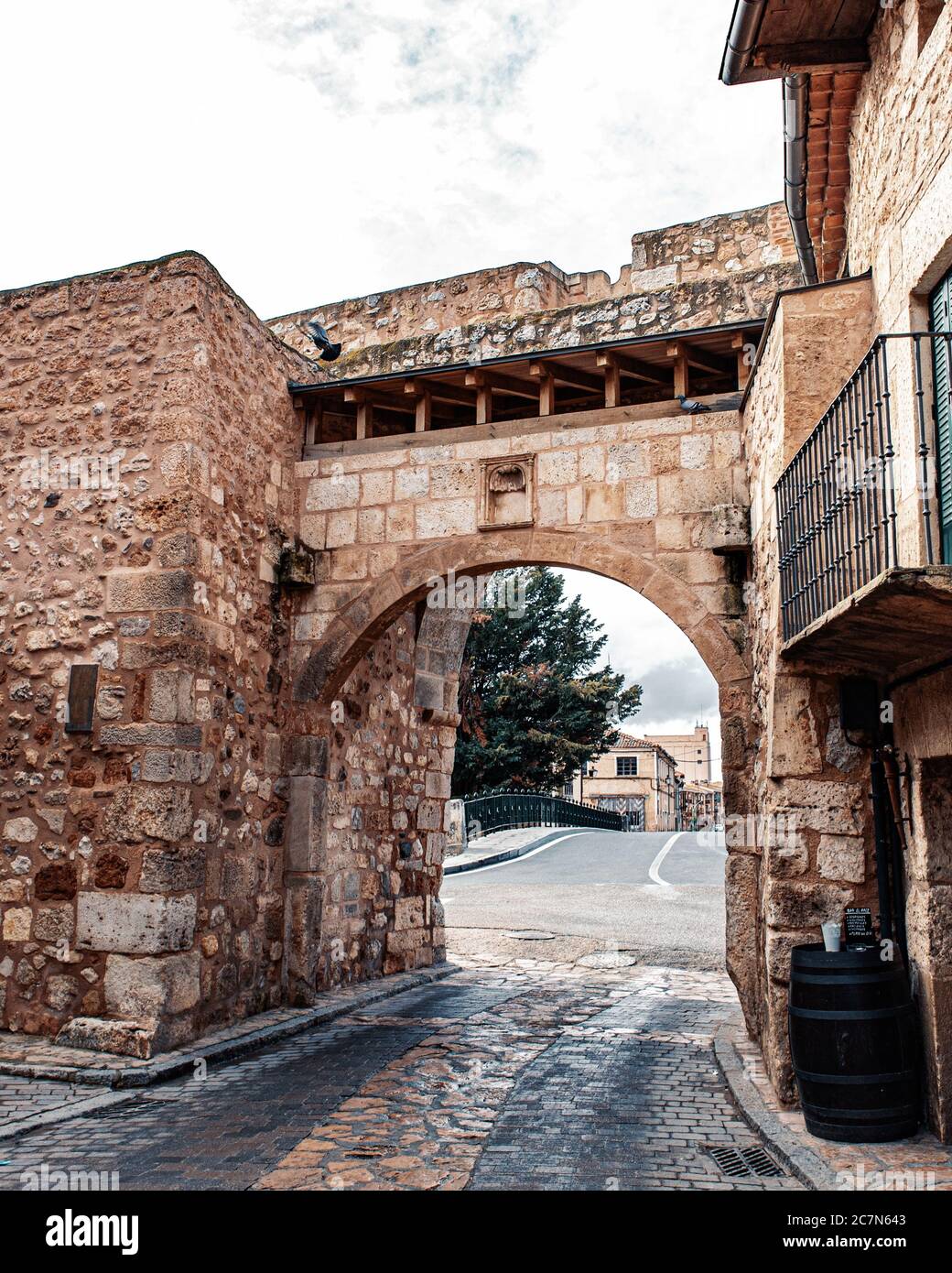 Road under the beautiful medieval-styled arch Stock Photo - Alamy