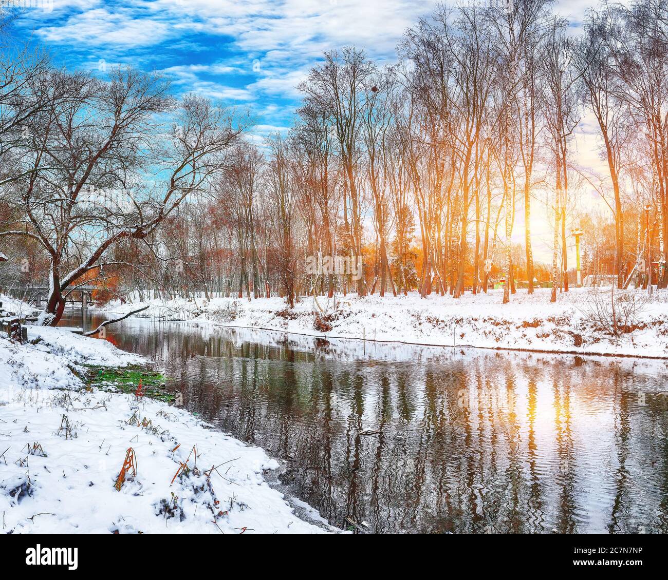Winter landscape by a river in the sunset. Mirror reflection Stock ...