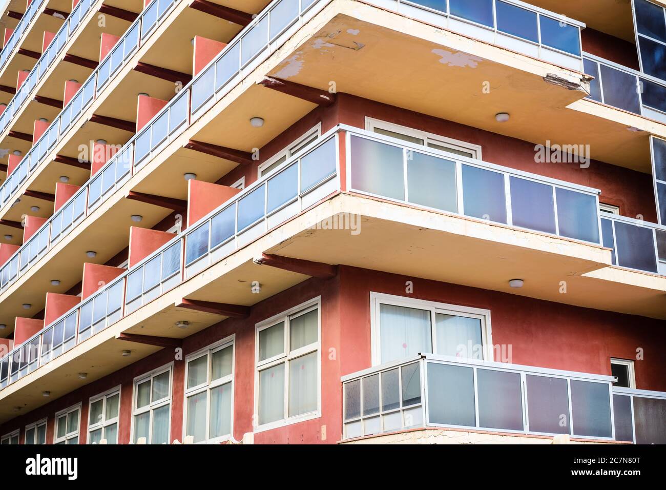 Red old building with glass balconies Stock Photo - Alamy