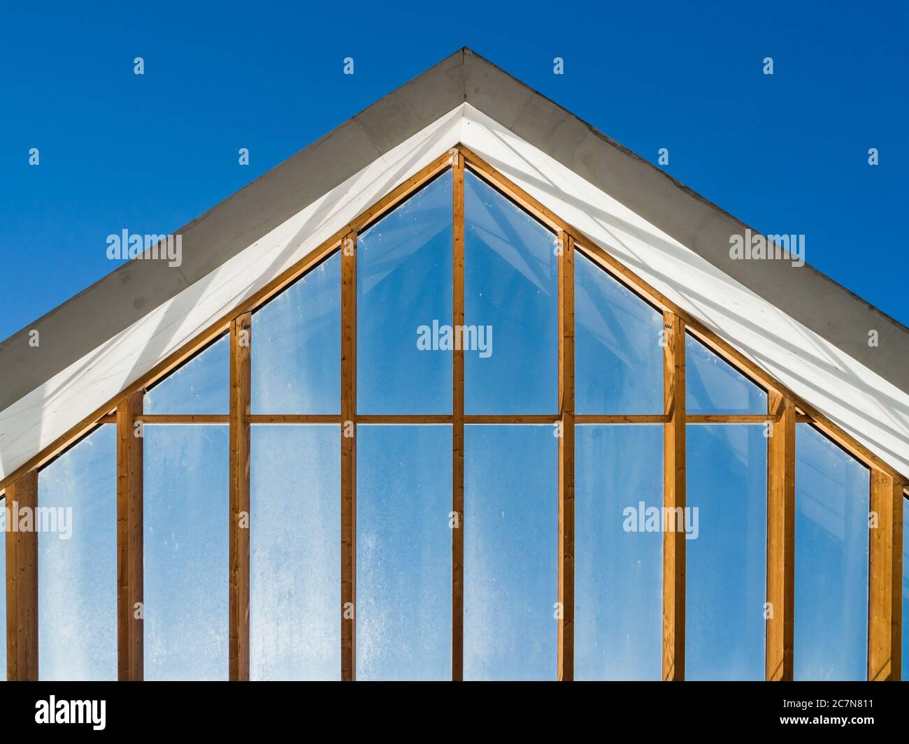 Modern, huge triangle, glass roof under the blue sky Stock Photo - Alamy