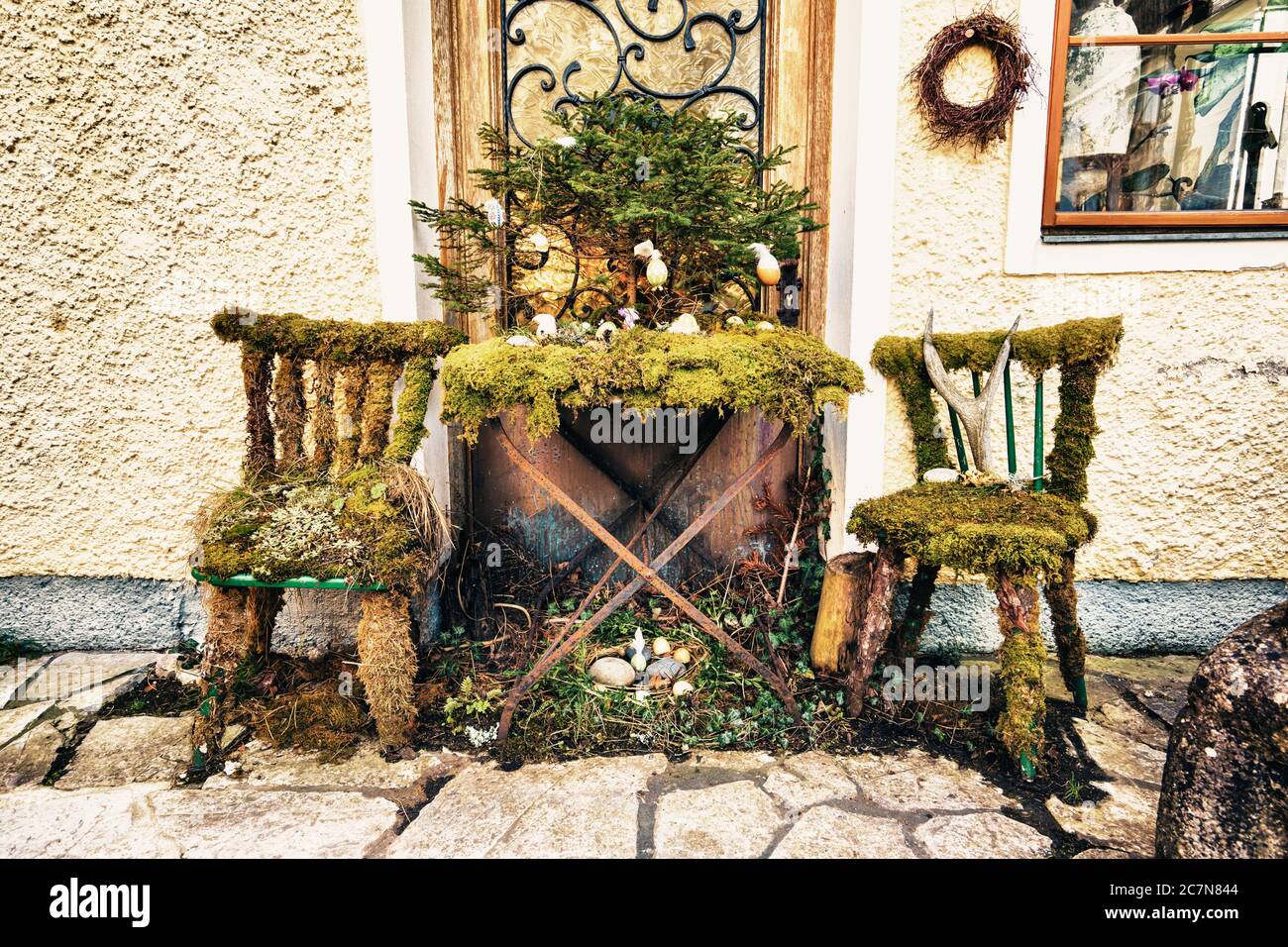 Old stone house with old tables and chairs covered in moss Stock Photo ...