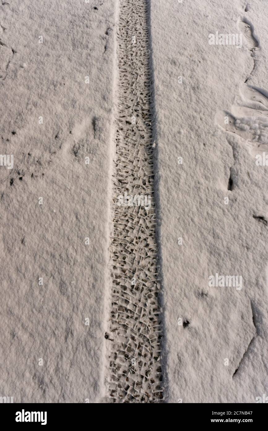 Tread marks on fresh snow. Track from car tire. Road covered with a ...