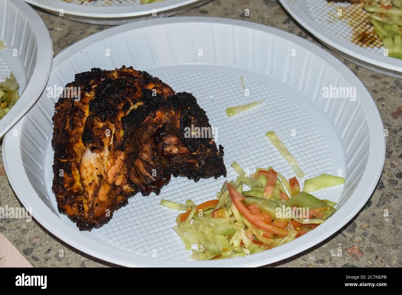 The slightly burned barbecue chicken with a vegetable salad Stock Photo ...
