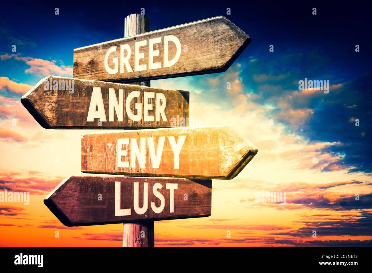 Greed, anger, envy, lust - wooden signpost, roadsign with four arrows ...