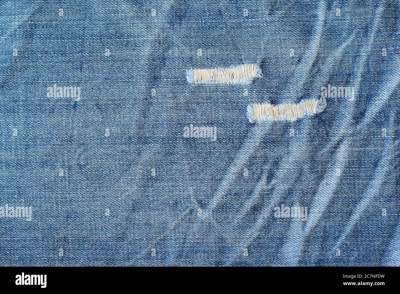 Closeup shot of a blue torn denim fabric - perfect for backgrounds ...