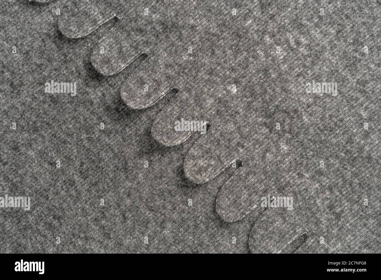 Woolen gray warm material close-up with folds and pattern. Abstract ...