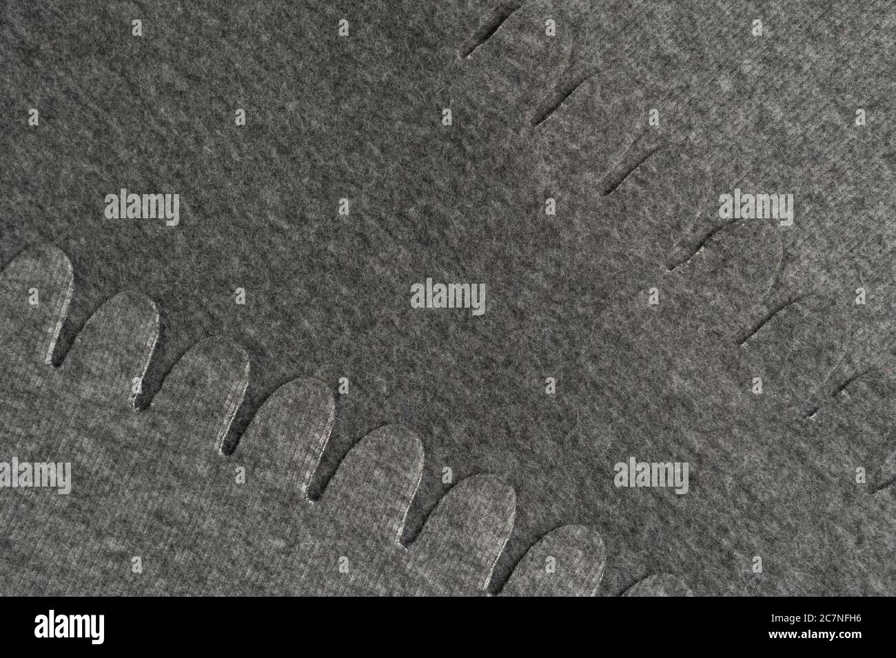 Gray wool material with patterned edges. Close-up. Abstract background ...