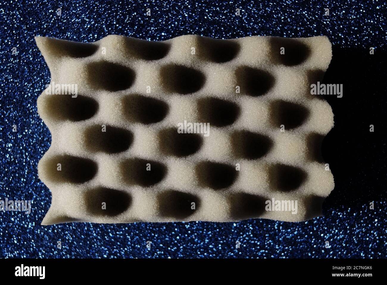Top view of a white packaging foam on a blue surface Stock Photo - Alamy