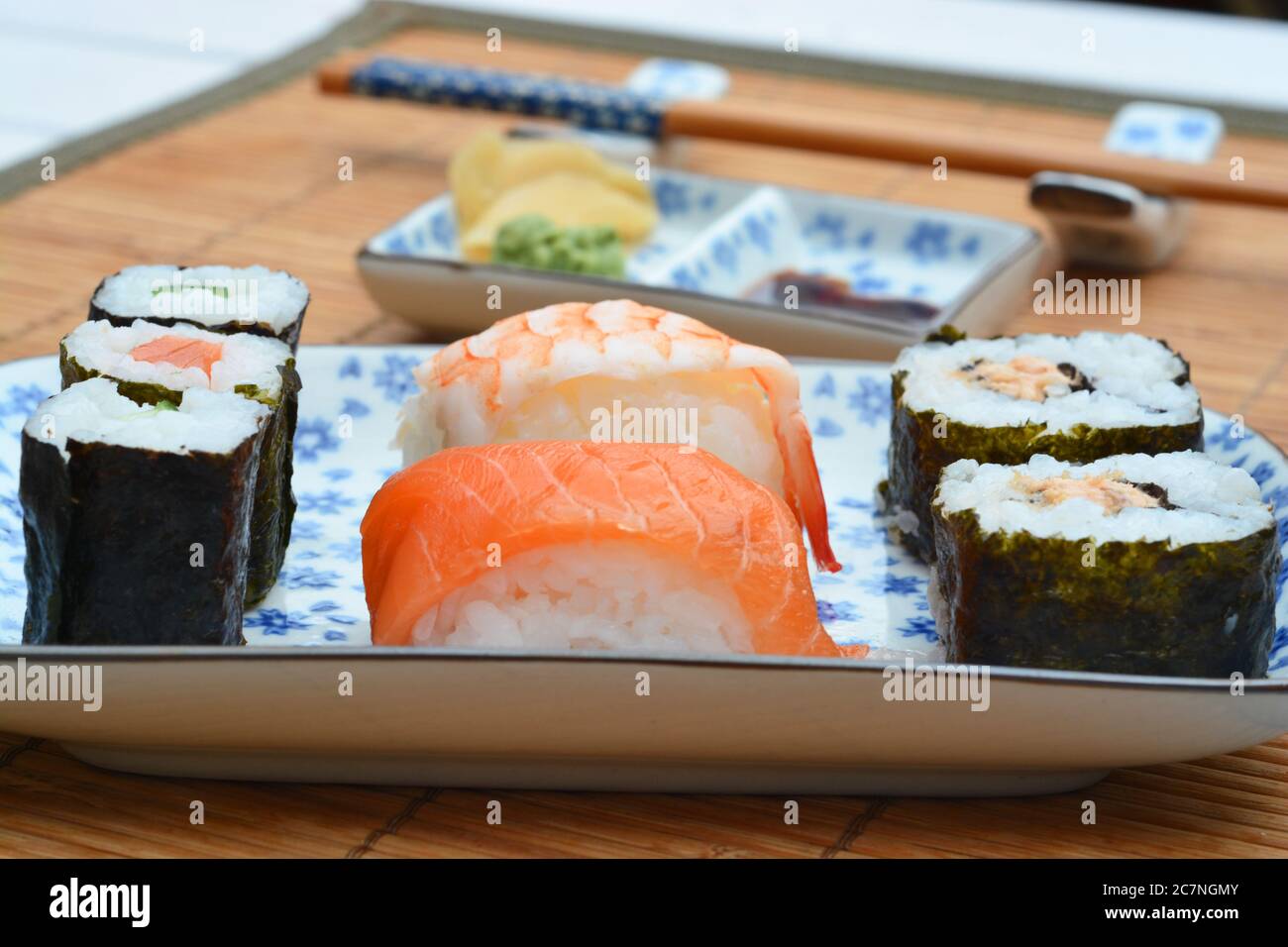 Shallow focus closeup shot of sushi rolls, sauce, and dumplings in ...