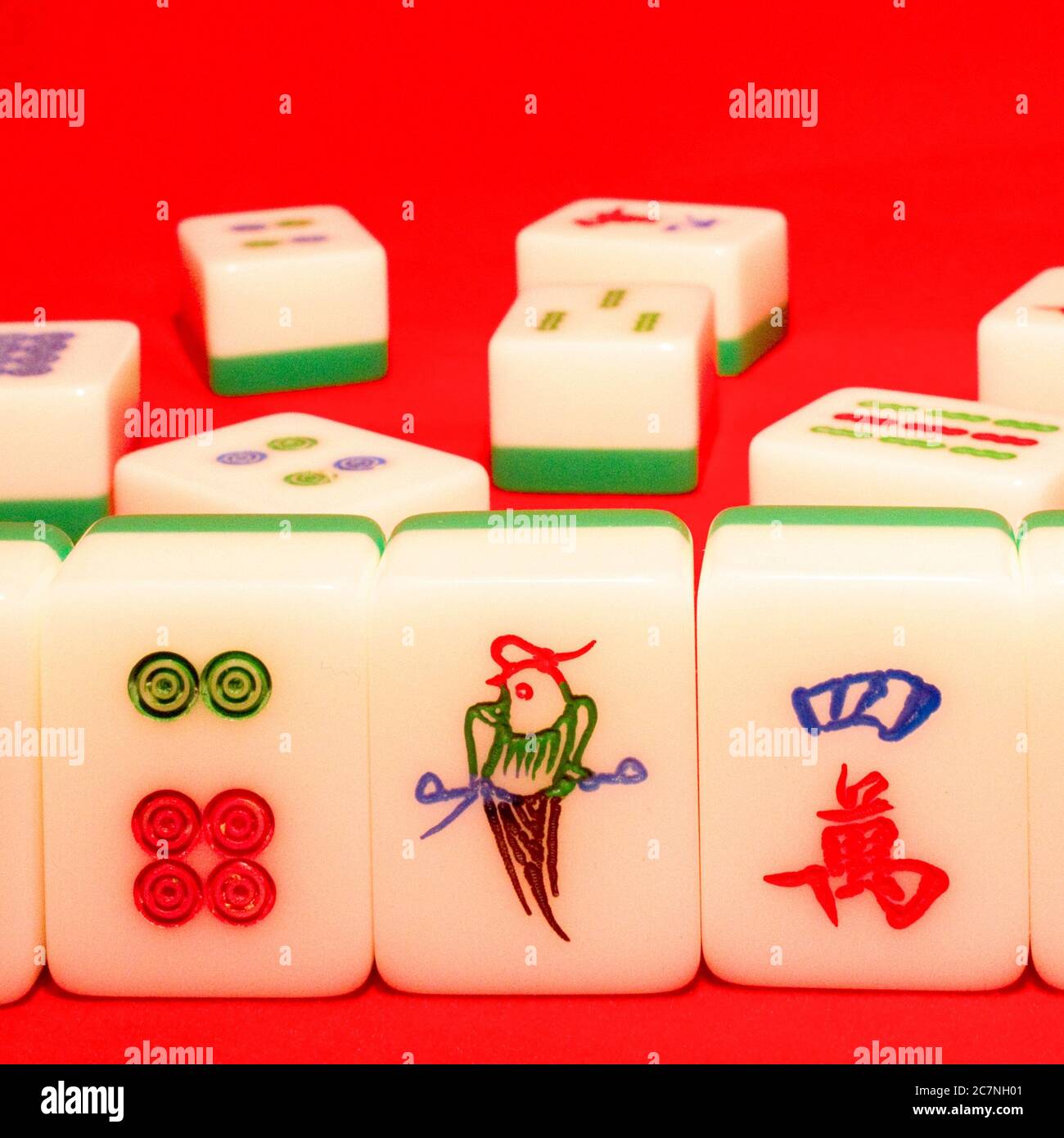 Closeup shot of mahjong game tiles in front of a red background Stock ...