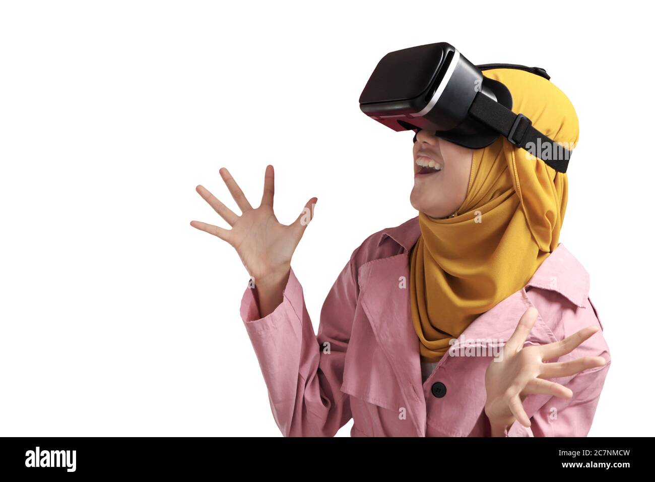 Happy young Asian muslim girl wearing hijab playing on VR glasses ...