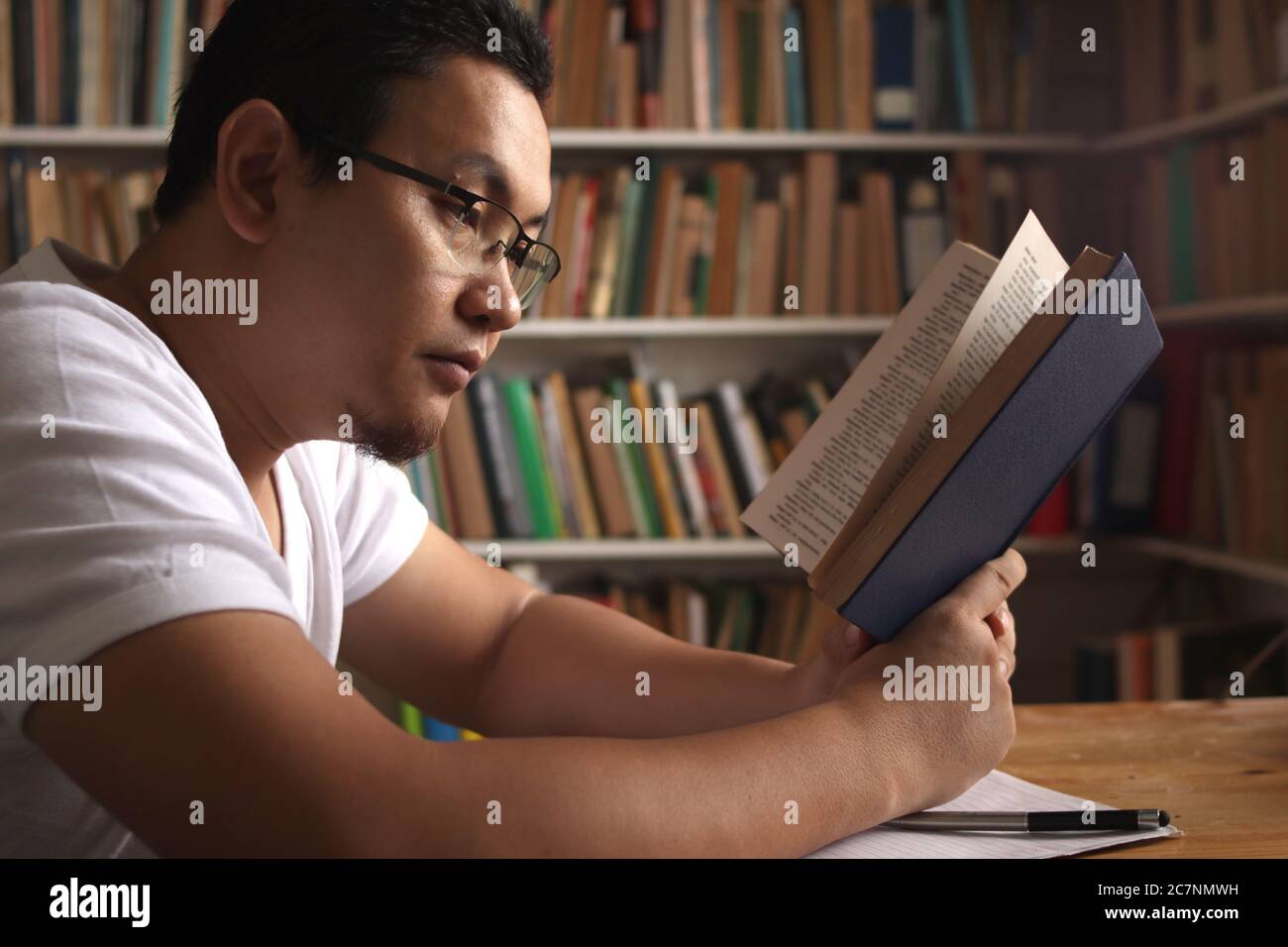Asian man reading book in library, educational concept. Happy smiling ...