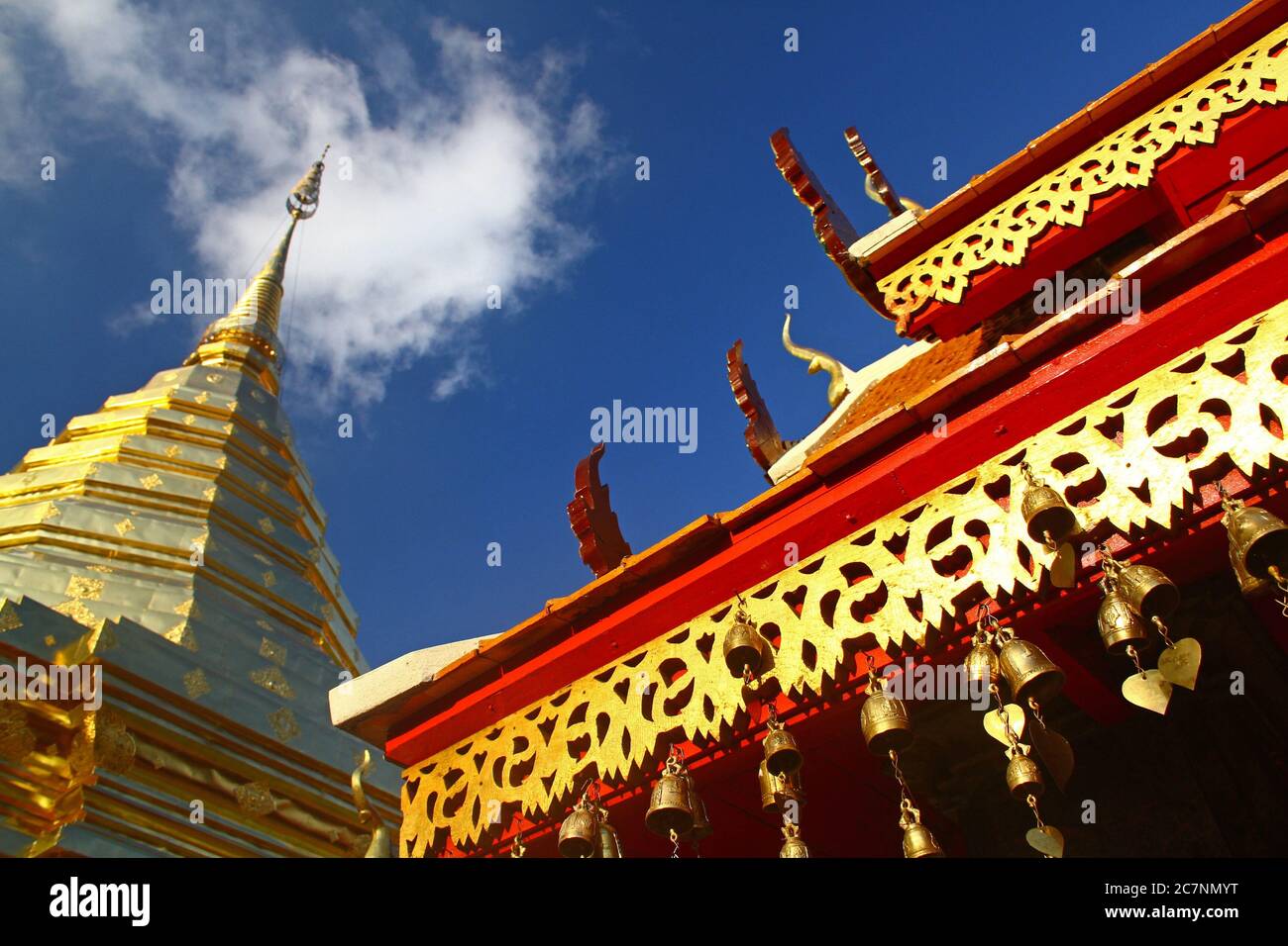 Low angle shot of the Asian temple with a red roof and golden dome ...