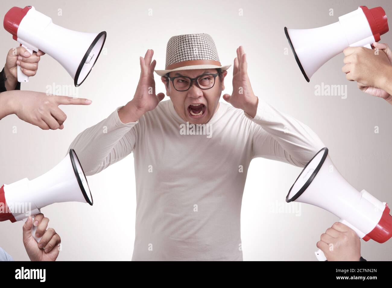 Young asian man covered his ear ignoring noise. Stressed under pressure ...