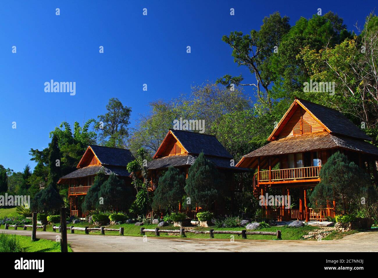 Wooden two-floor cottages with balconies located on a forest Stock ...