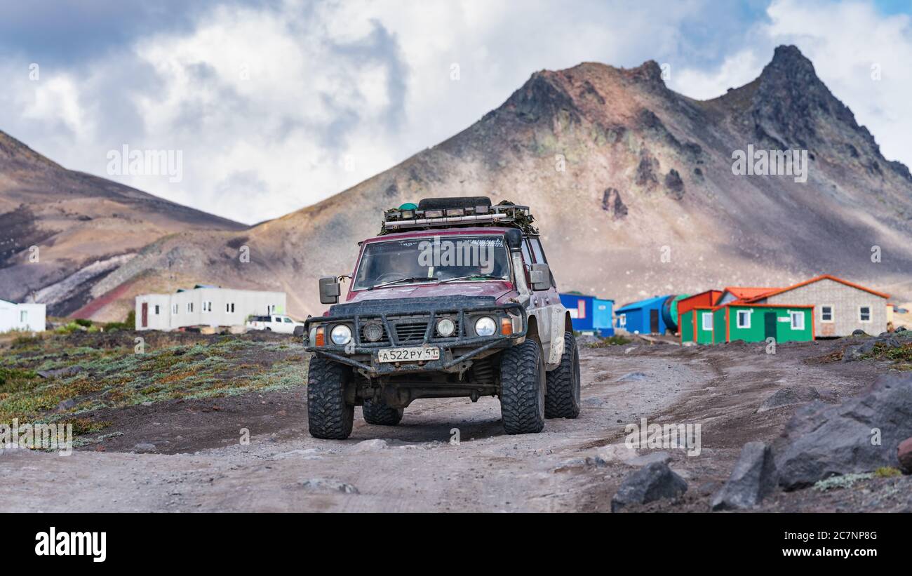 Japanese four-wheel drive vehicles Nissan Patrol driving on mountain ...