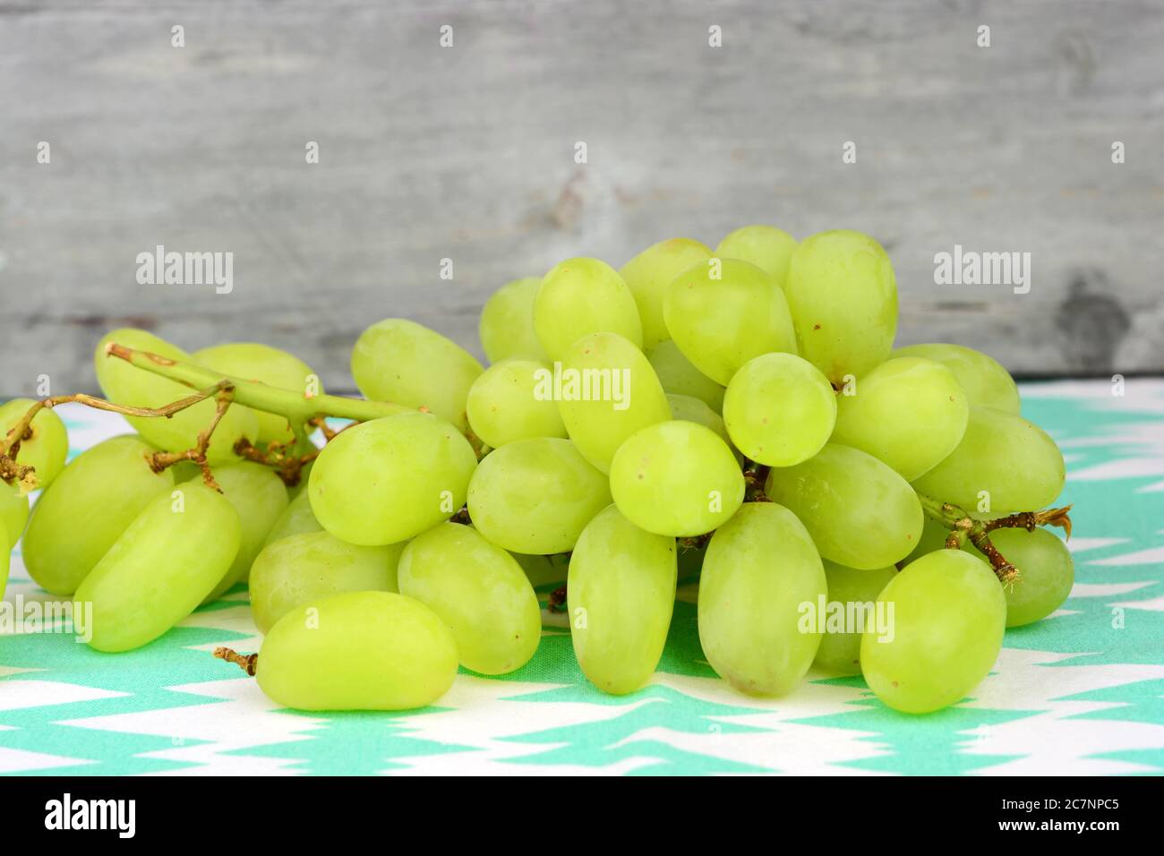 Closeup of a green grape on a table Stock Photo - Alamy