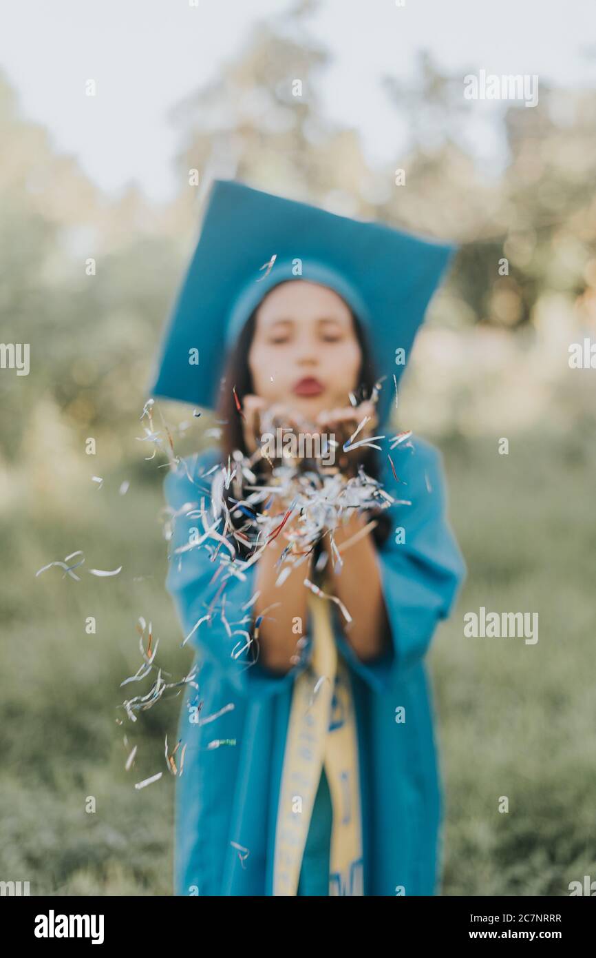 A Senior Graduate Filipino Women in her Graduation Gown and Cap while ...