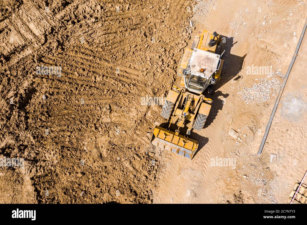 aerial top view of yellow wheel loader at road construction site. heavy ...
