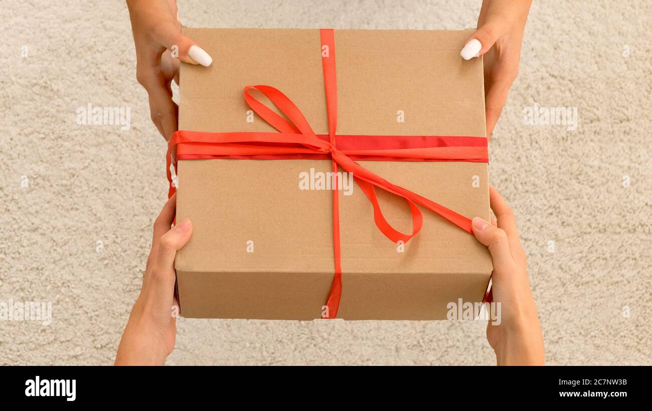 Men's hands give a box with a gift to a woman Stock Photo - Alamy