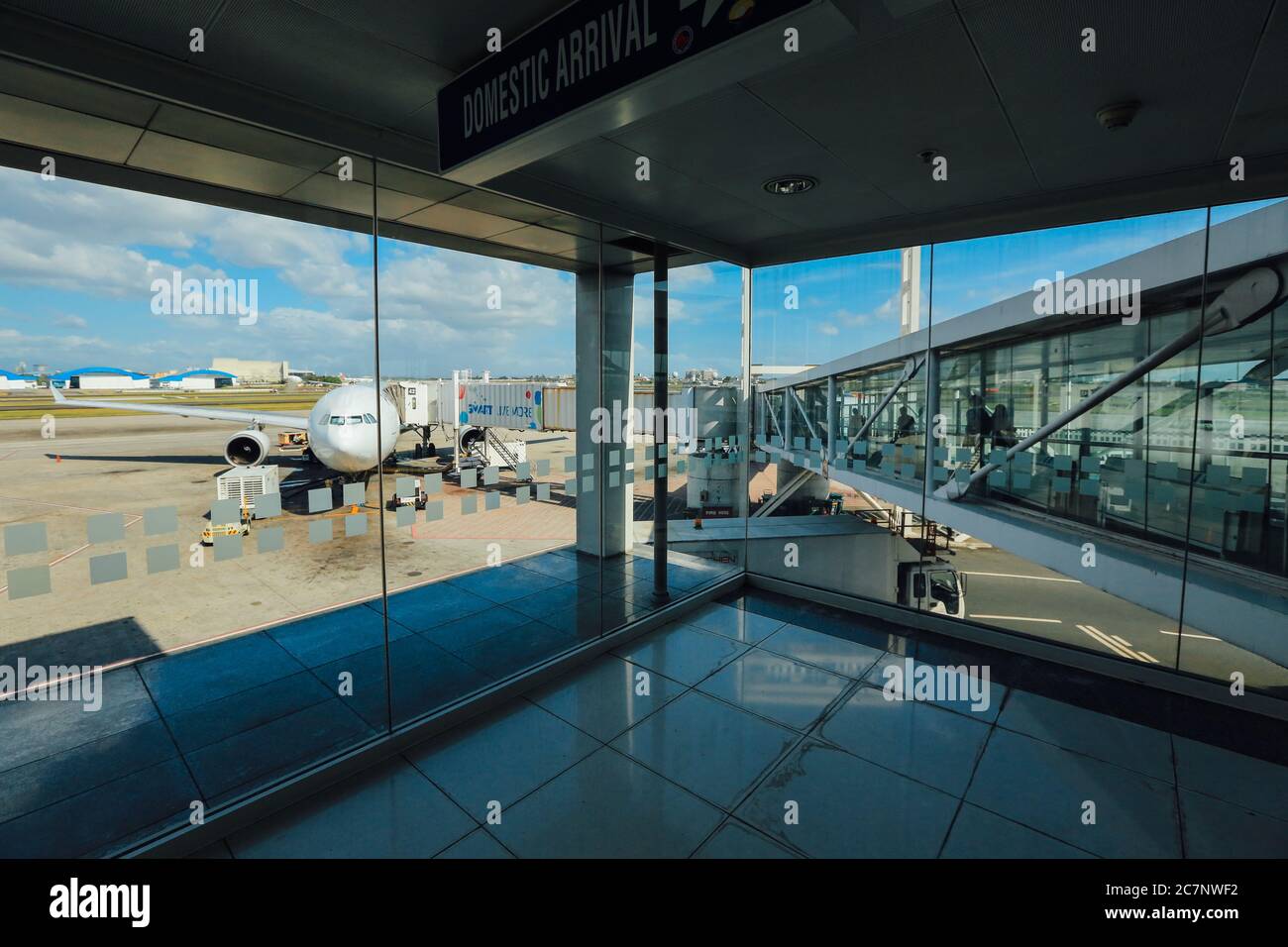 Plane which is boarding through the gate captured from the inside on an ...