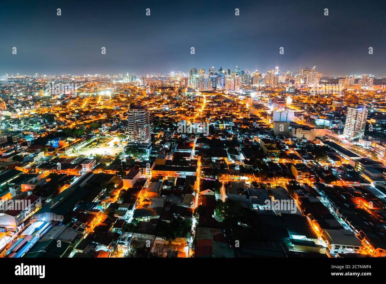 Aerial view of the urban city with skyscrapers and glowing lights at ...